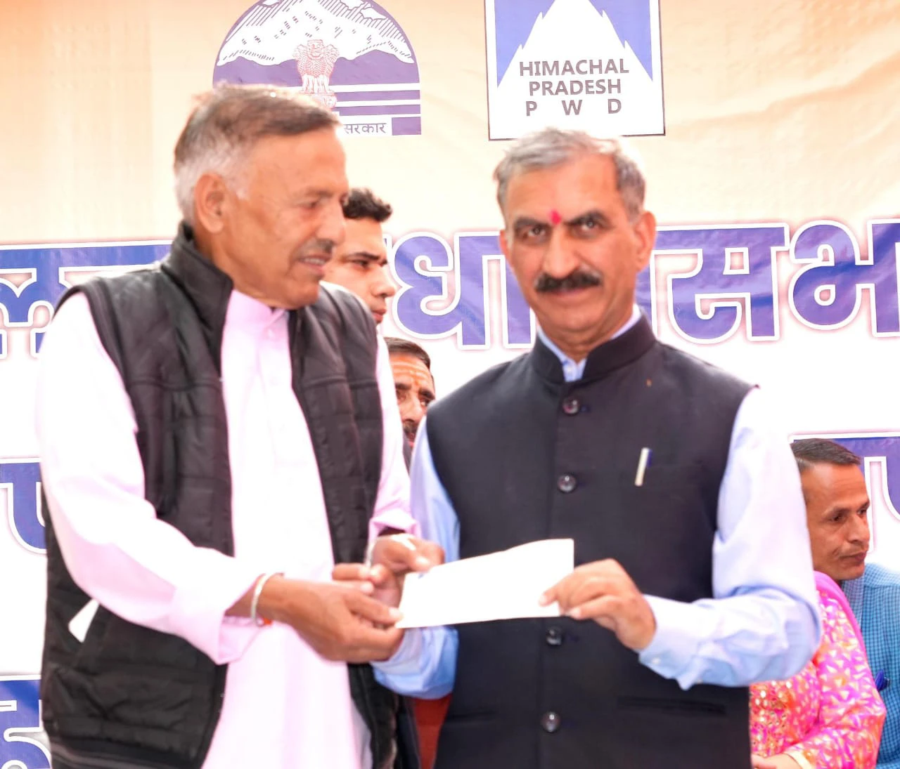 CM presented cheque of Rs. 50000 by O.P. Sharma Retd. Deputy Registrar ...